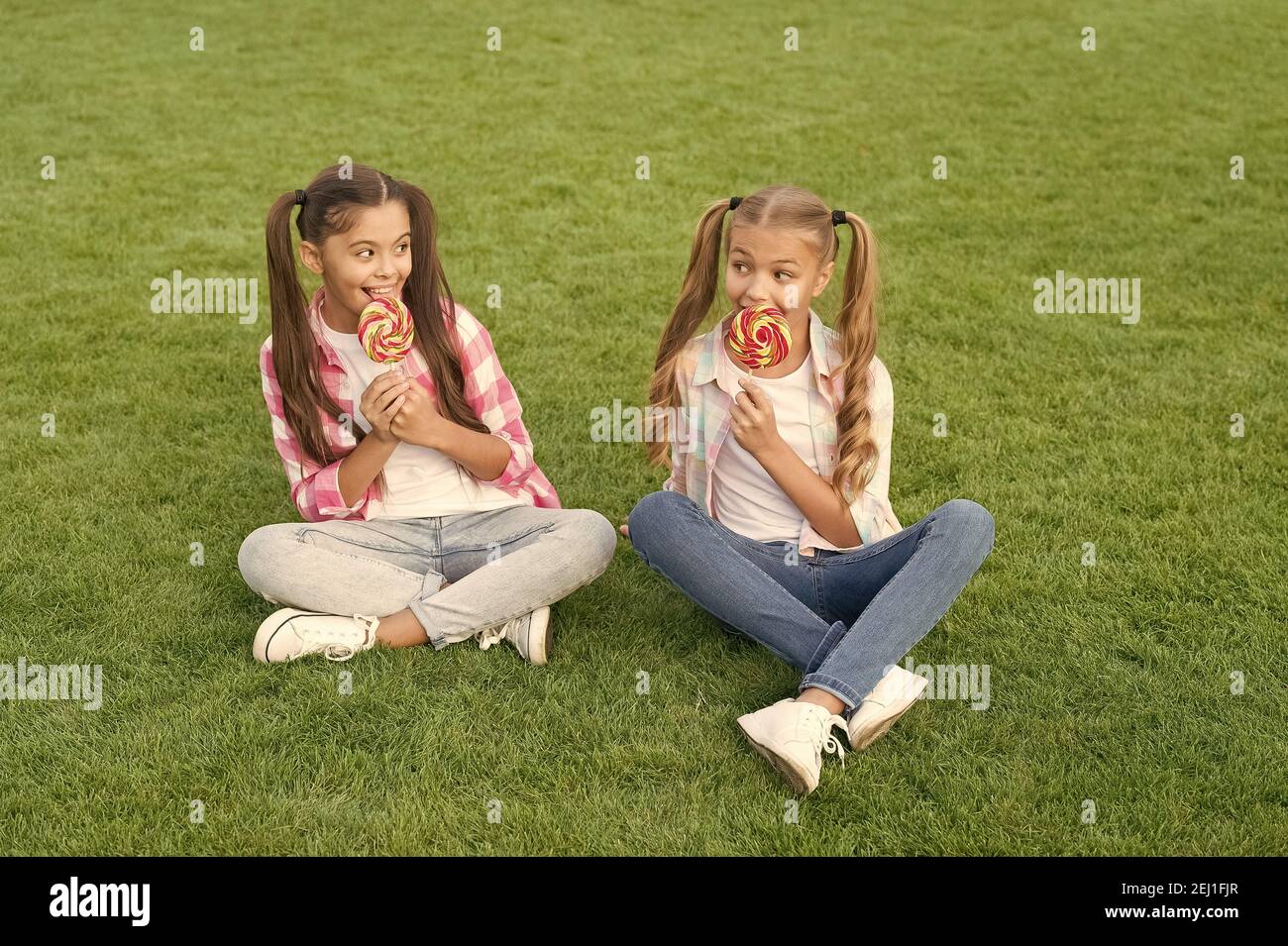Sugar and calories. Joyful cheerful friends eating sweets outdoors ...
