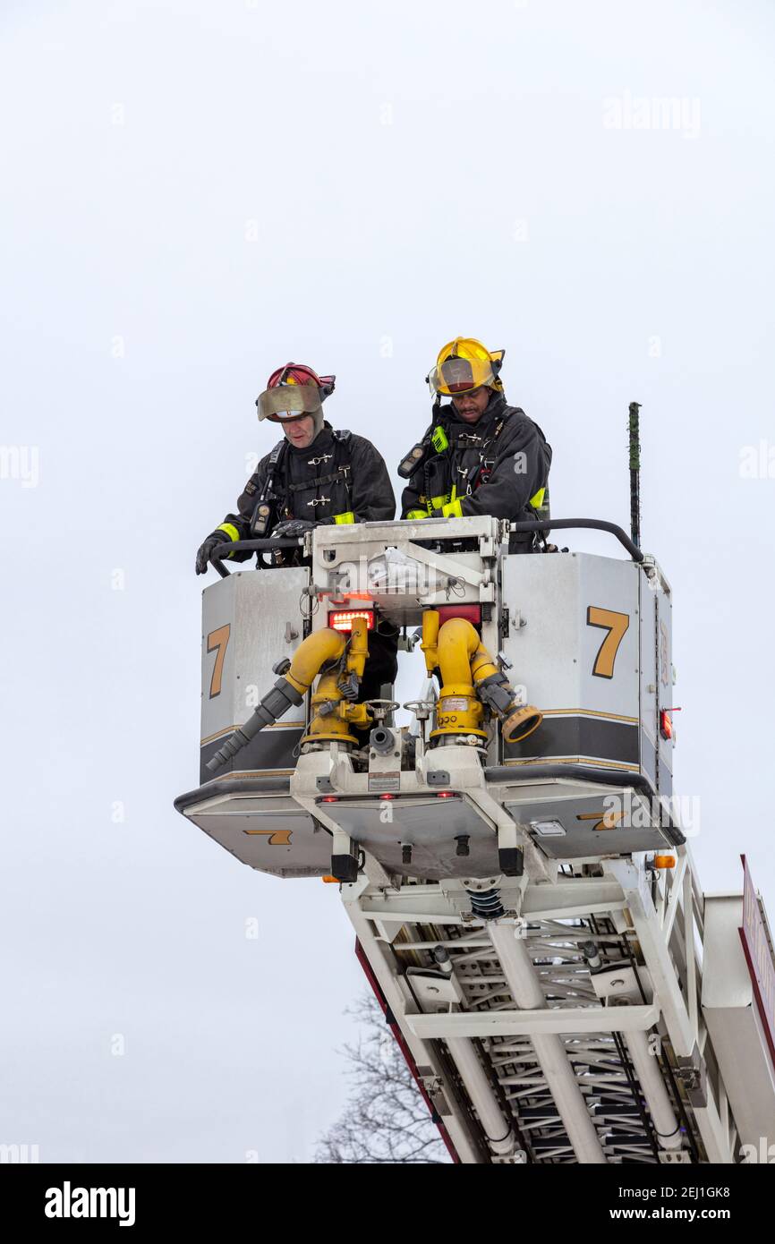 Firefighters in Tower Ladder fighting fire, Detroit, Michigan, USA, by ...
