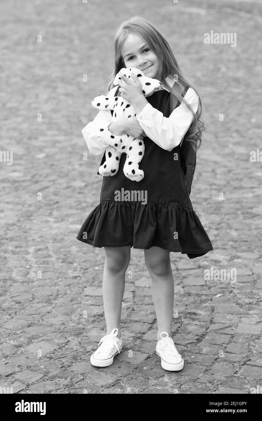 Make time for play. Happy kid hug toy outdoors. Toy friend. Educational ...