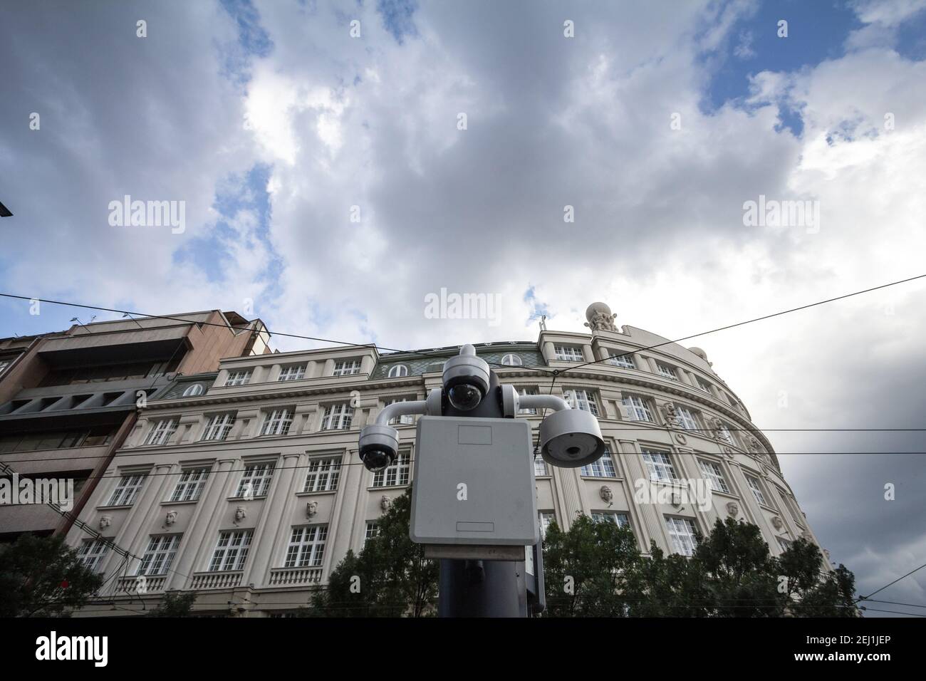 Two dome cctv cameras seen from below in front of an old building in a ...