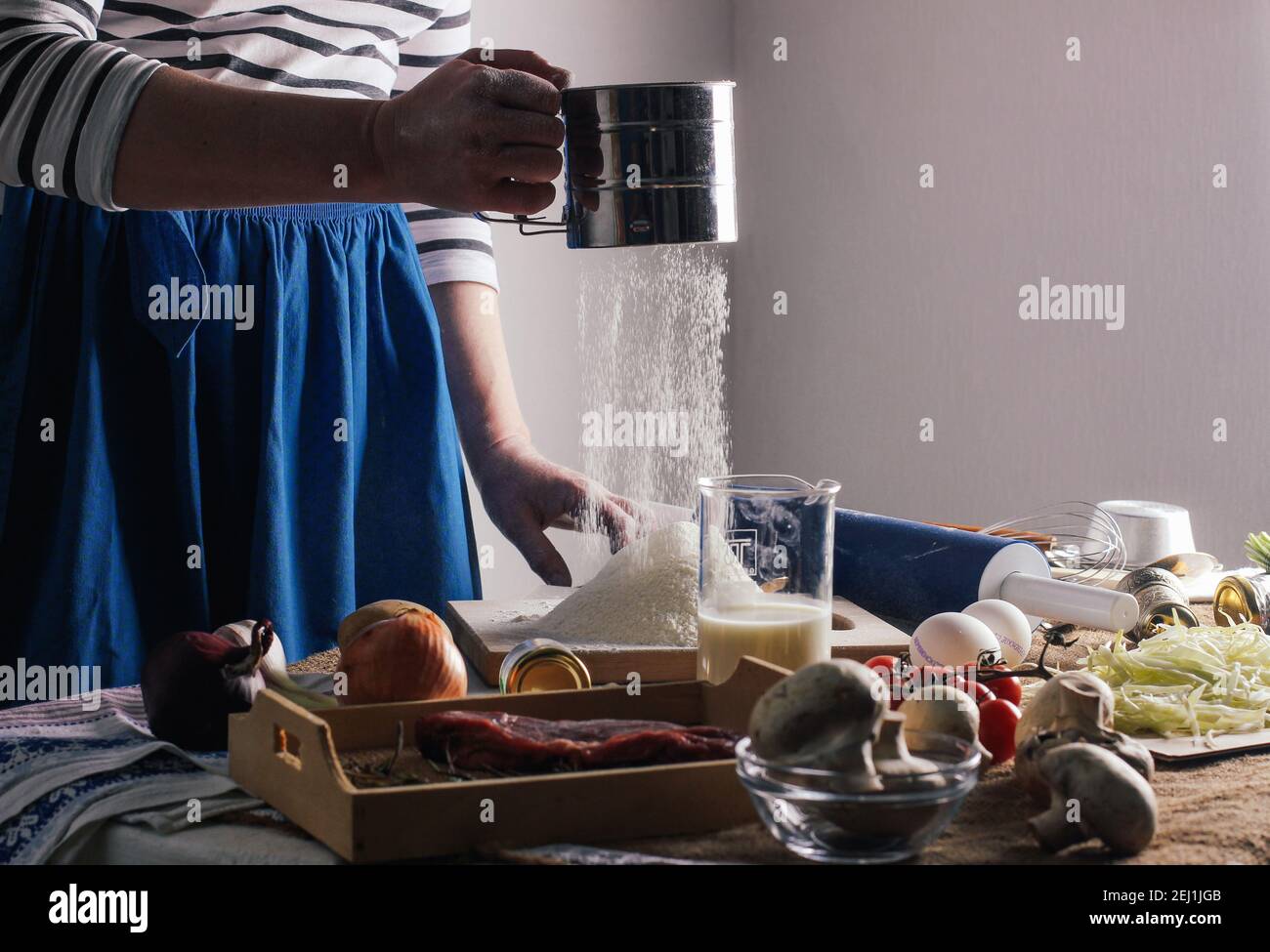 A woman holding a jug while cooking. Kazakhstan Stock Photo - Alamy