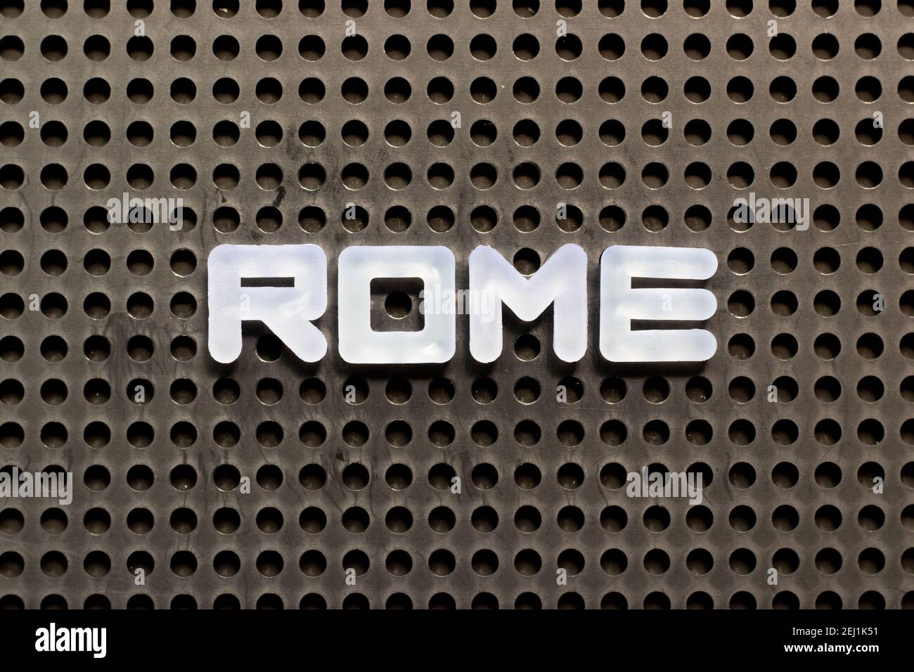 White color letter in word rome on black pegboard background Stock ...