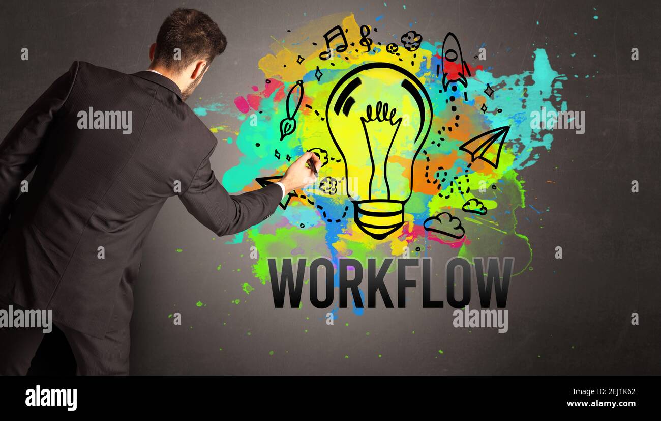 businessman drawing colorful light bulb with WORKFLOW inscription on ...