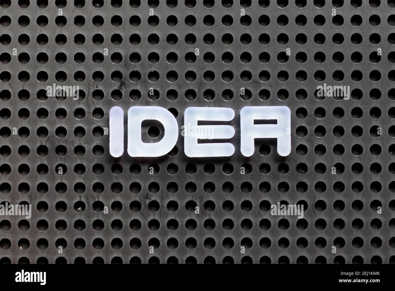White color letter in word idea on black pegboard background Stock ...
