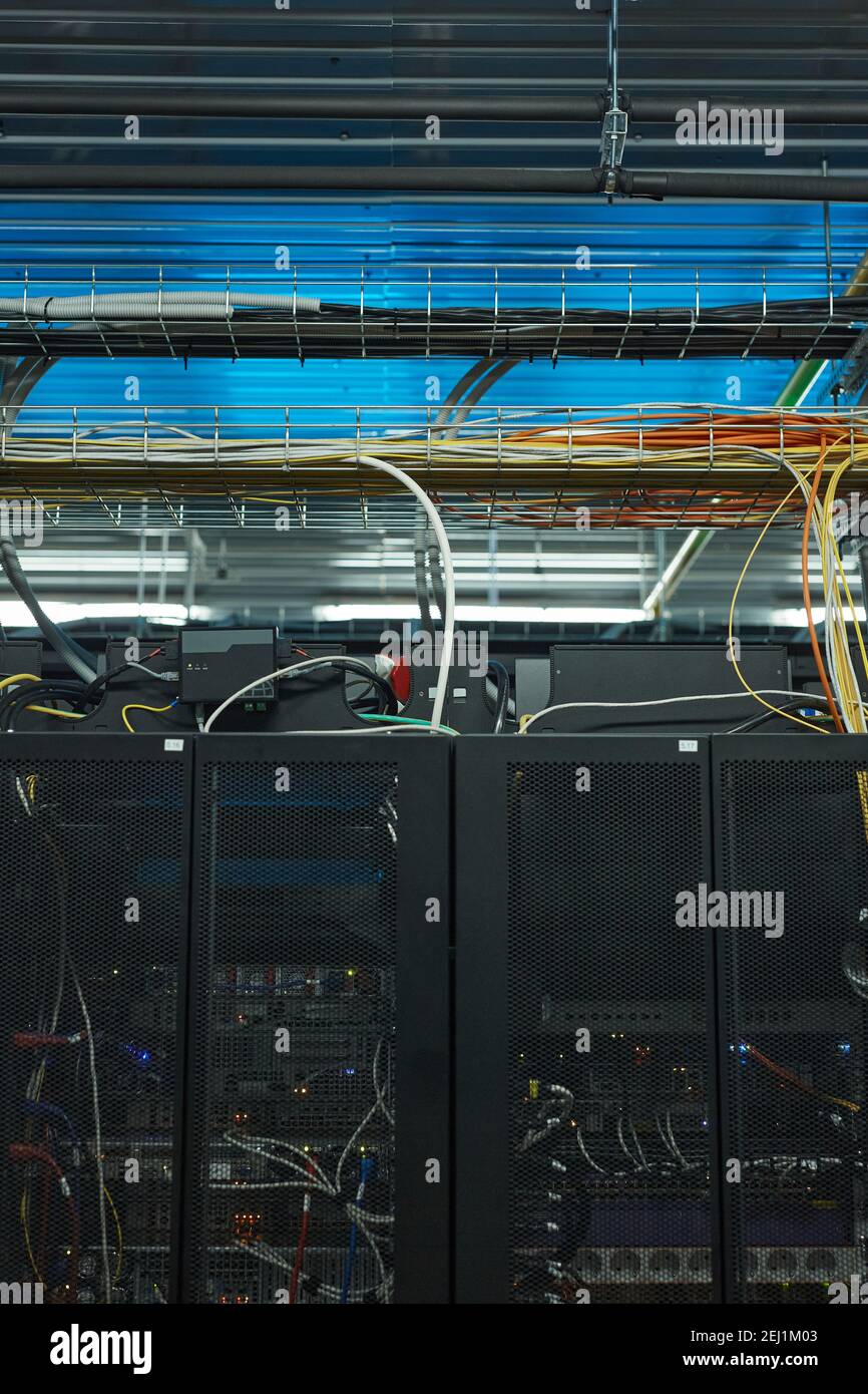 Vertical background image of server cabinet with cables and wires in ...