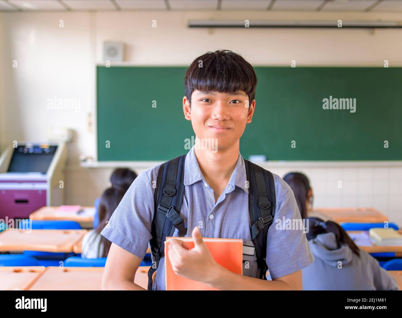 Smiling asian student teenager boy in classroom Stock Photo - Alamy