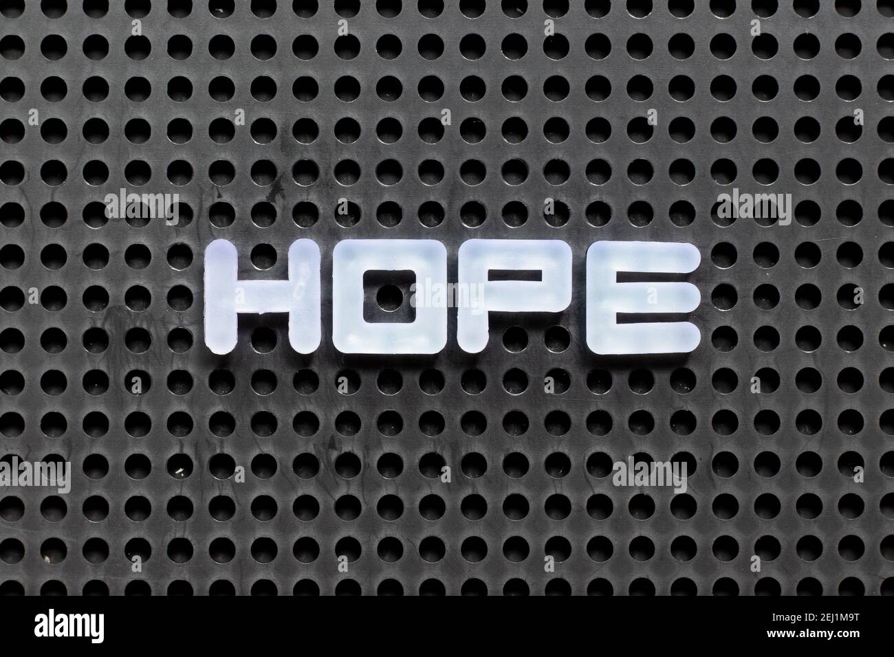 White color letter in word hope on black pegboard background Stock ...