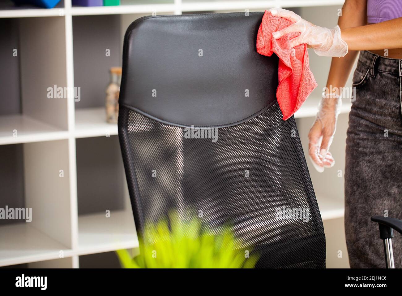 Woman cleaning office chair with a wipe Stock Photo - Alamy