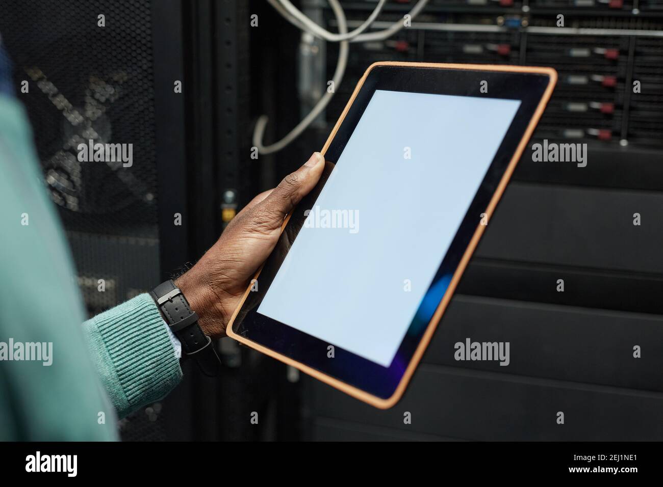 Close up of African American data engineer holding digital tablet with ...