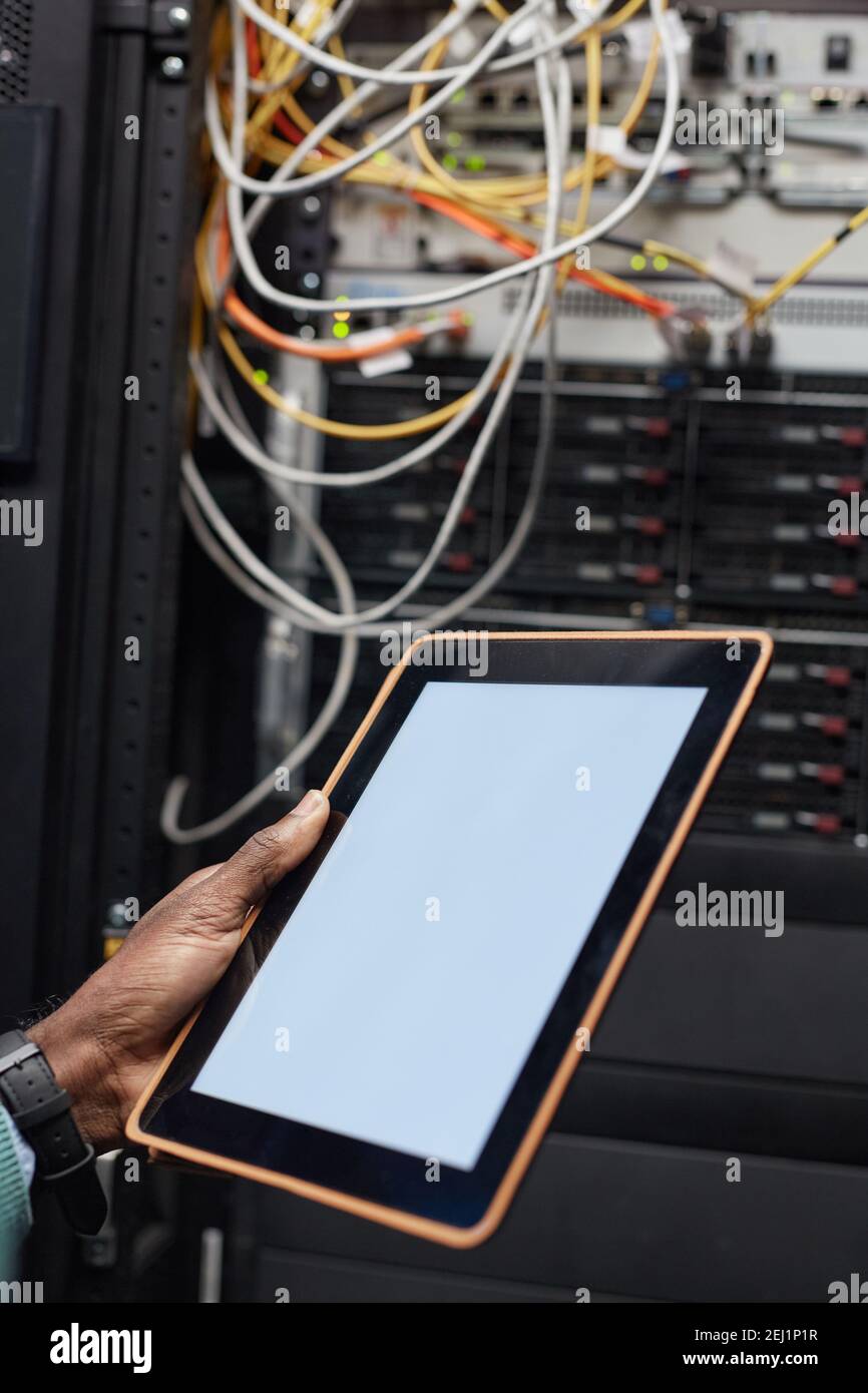 Vertical closeup of African American data engineer holding digital ...