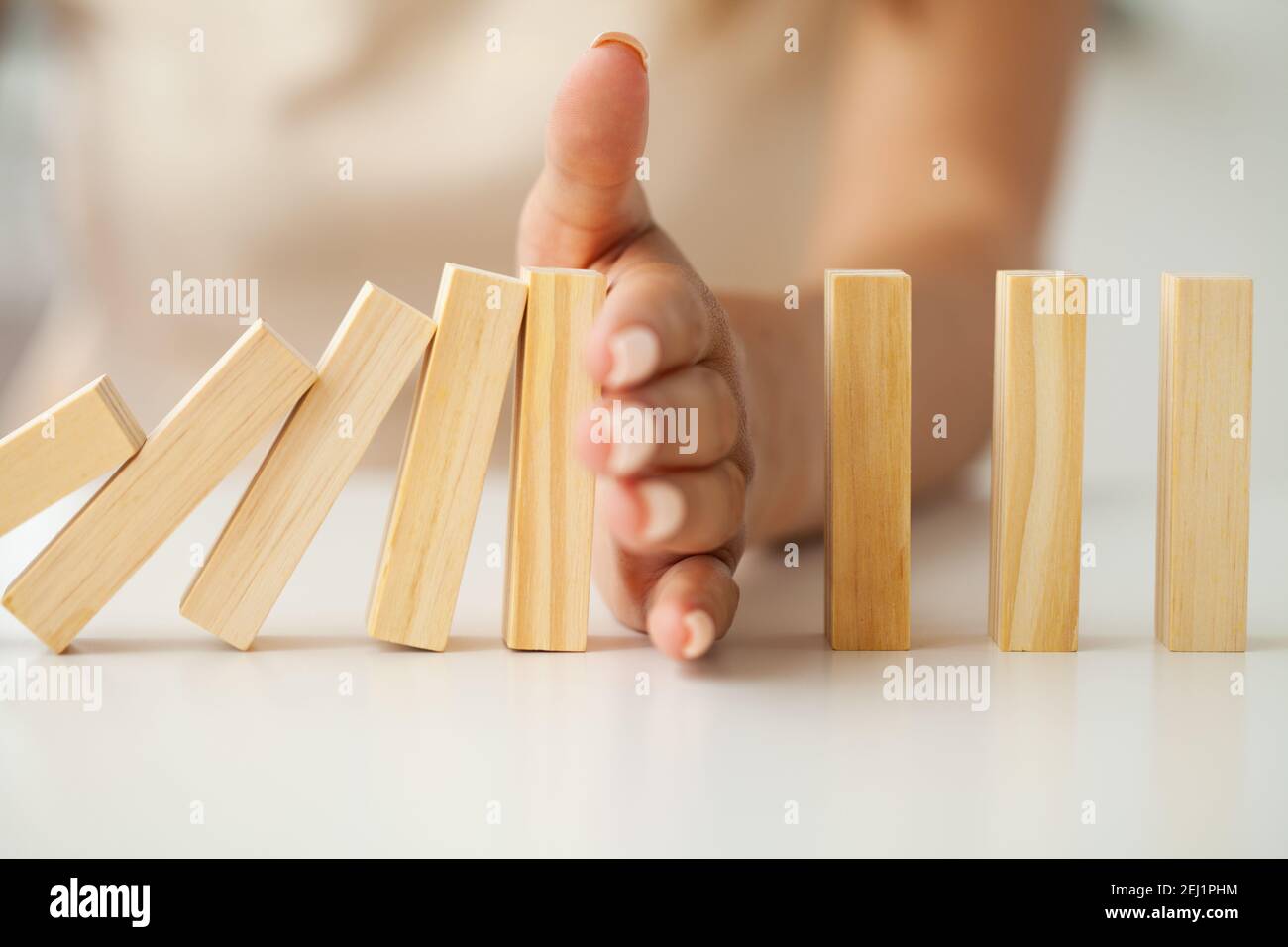 Hand putting and stacking blank wooden cubes on table with copy space ...