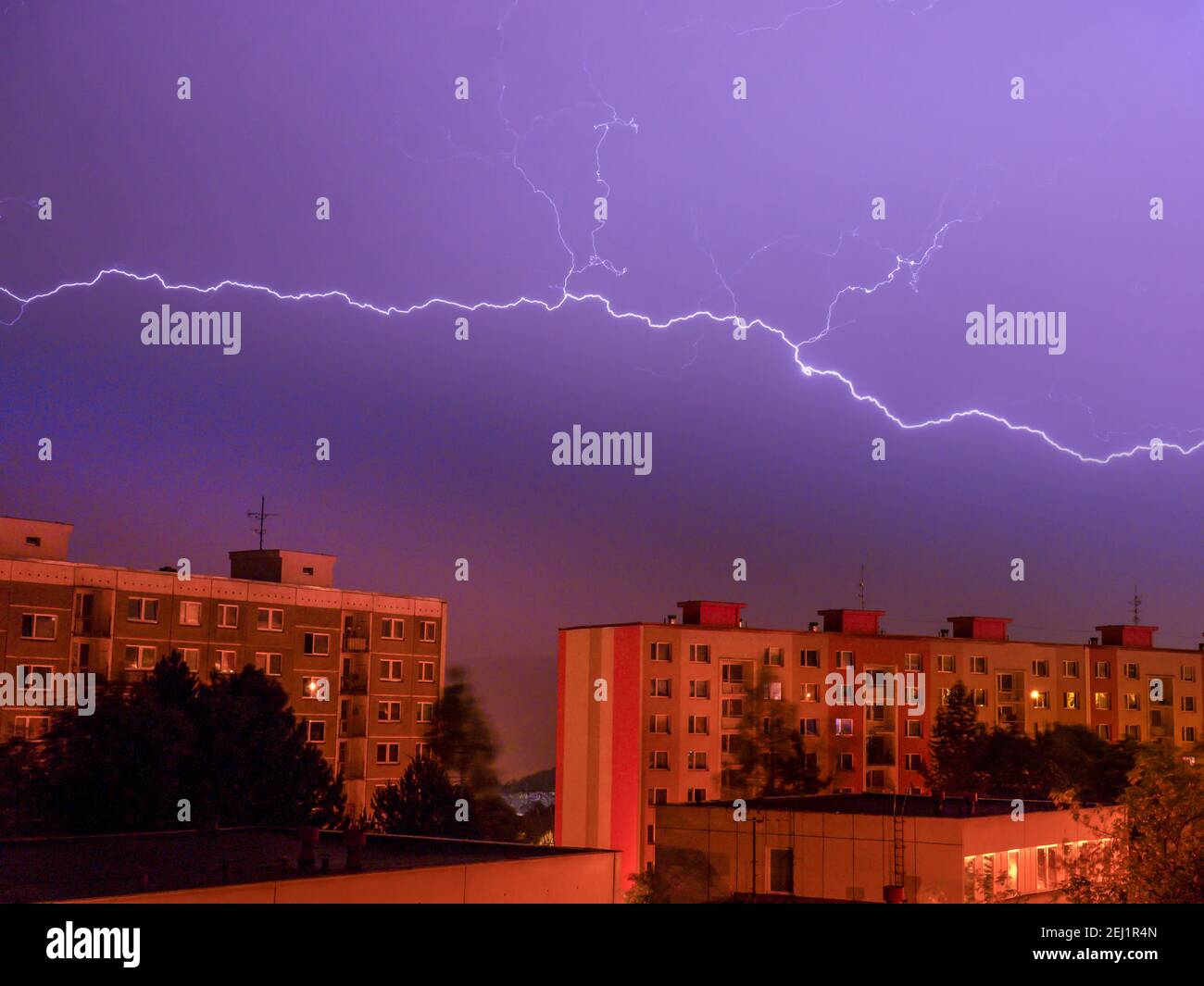 Lightning over city houses - long exposure at night Stock Photo - Alamy