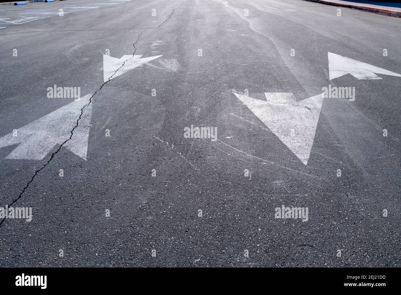 Arrows in a parking lot are pointing in opposite directions Stock Photo ... Arrows in a parking lot are pointing in opposite directions Stock Photo ...