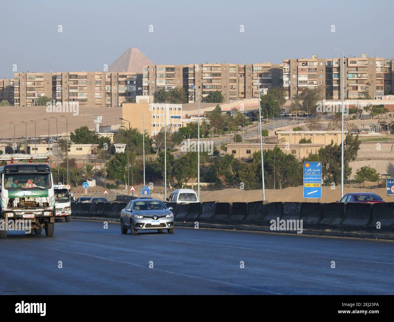 A street in Giza Egypt with traffic cars and vehicles with residential ...