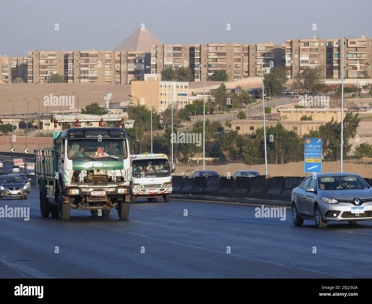A street in Giza Egypt with traffic cars and vehicles with residential ...