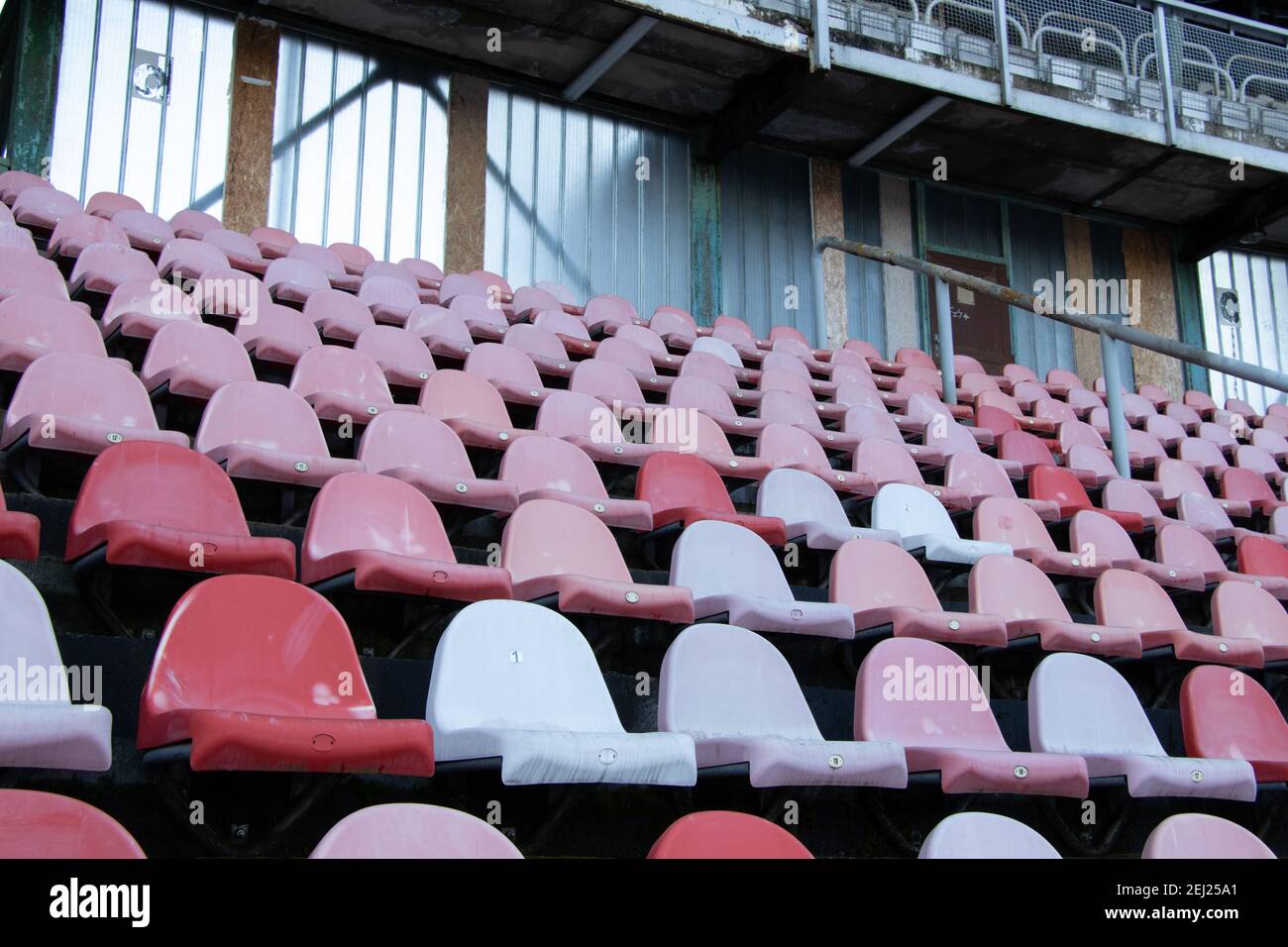 A low angle shot of old empty red bleachers in a stadium Stock Photo ...