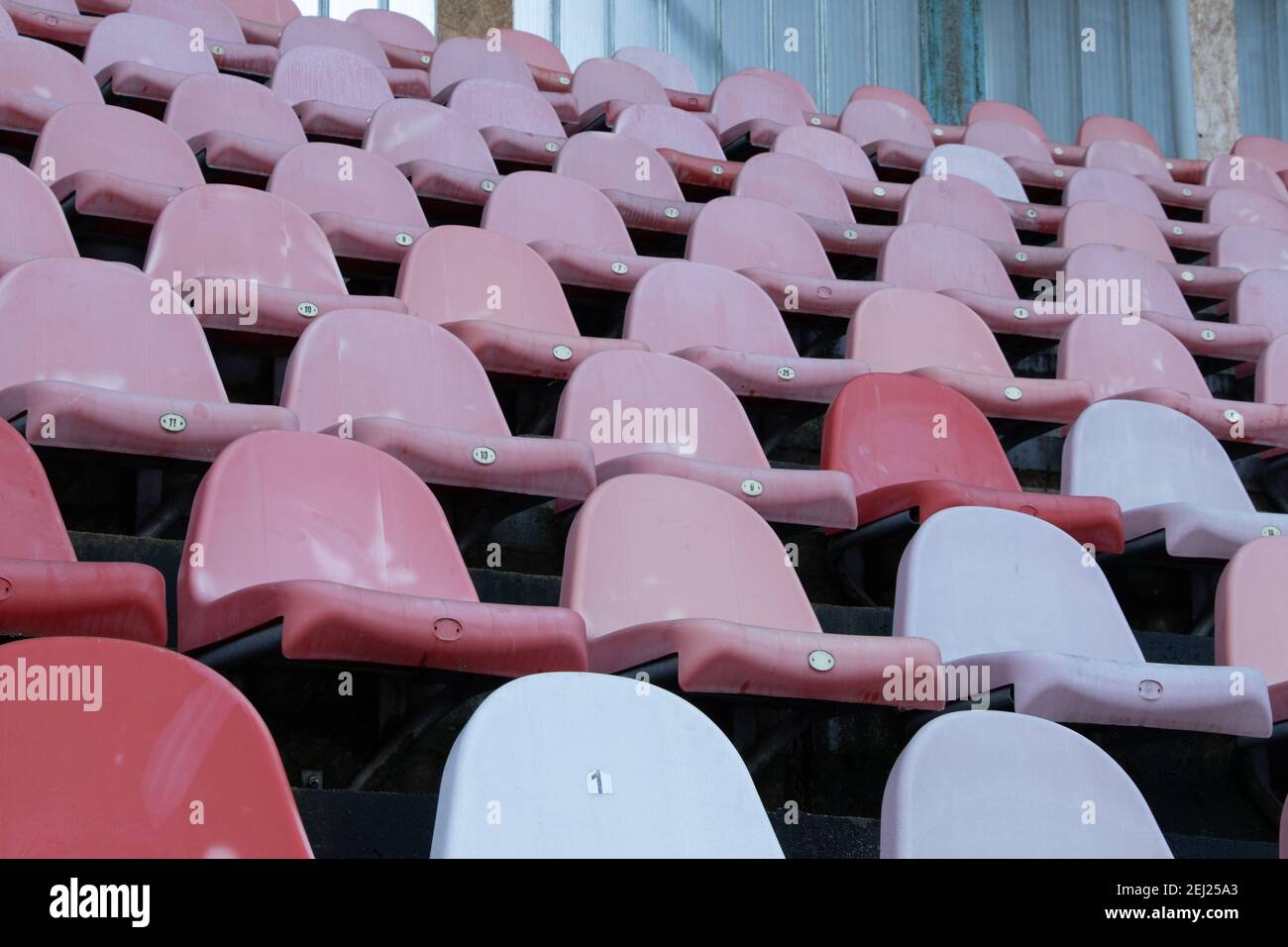 A low angle shot of old empty red bleachers in a stadium Stock Photo ...