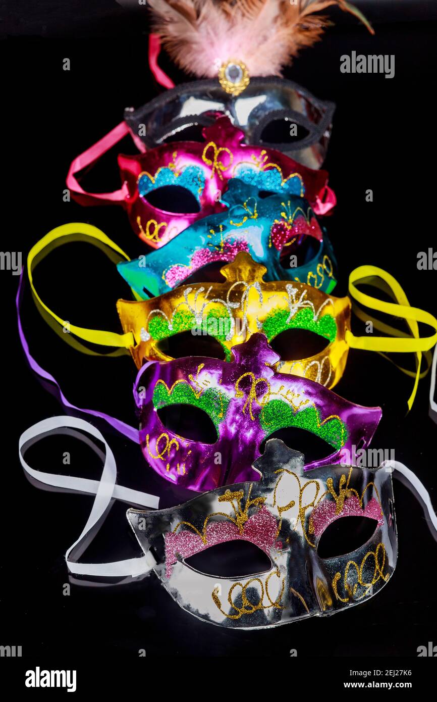 Carnival masks on black background. Jewish holiday Purim Stock Photo ...