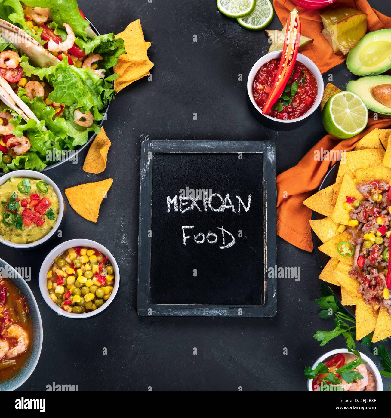 Delicious hispanic mexican meal board with nachos, tacos, guacamole ...