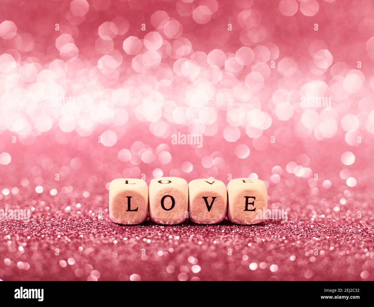 Lettering Love bright glitter lights bokeh background Stock Photo - Alamy