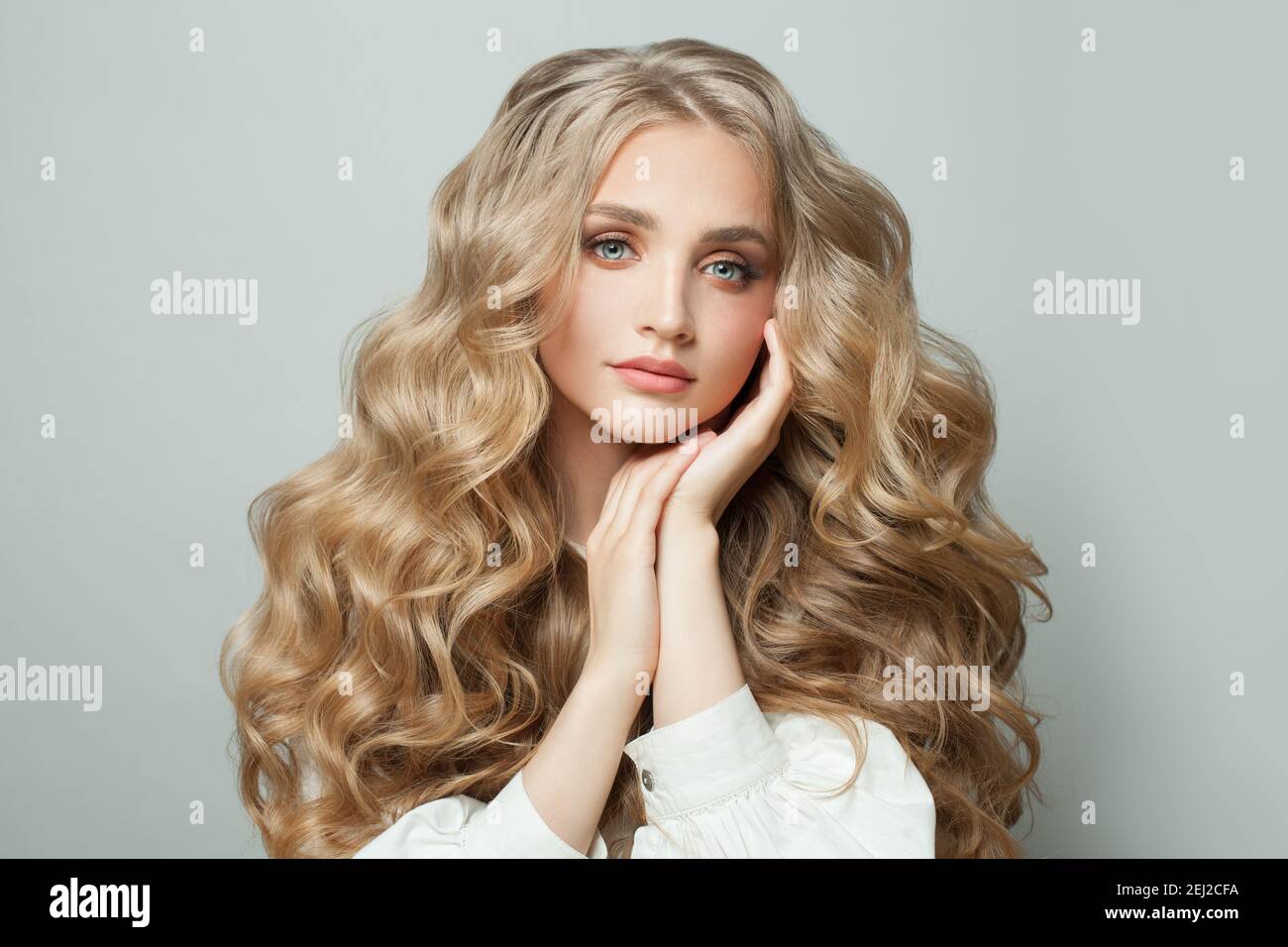 Nice woman fashion model with clear skin and healthy wavy hair on white ...