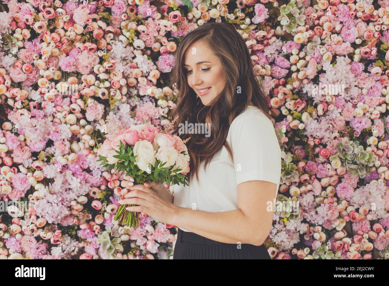 Portrait of beautiful woman with rose flowers on pink floral blossom ...