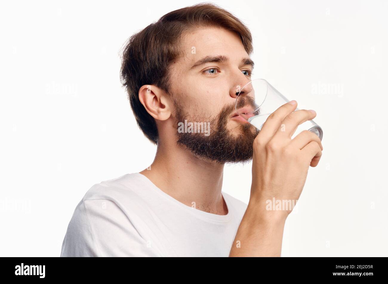 handsome man drinking water from a glass surprised look emotions white ...