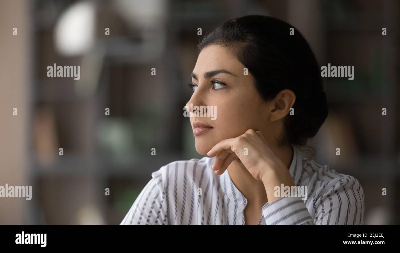 Pensive Indian woman look in distance thinking Stock Photo - Alamy