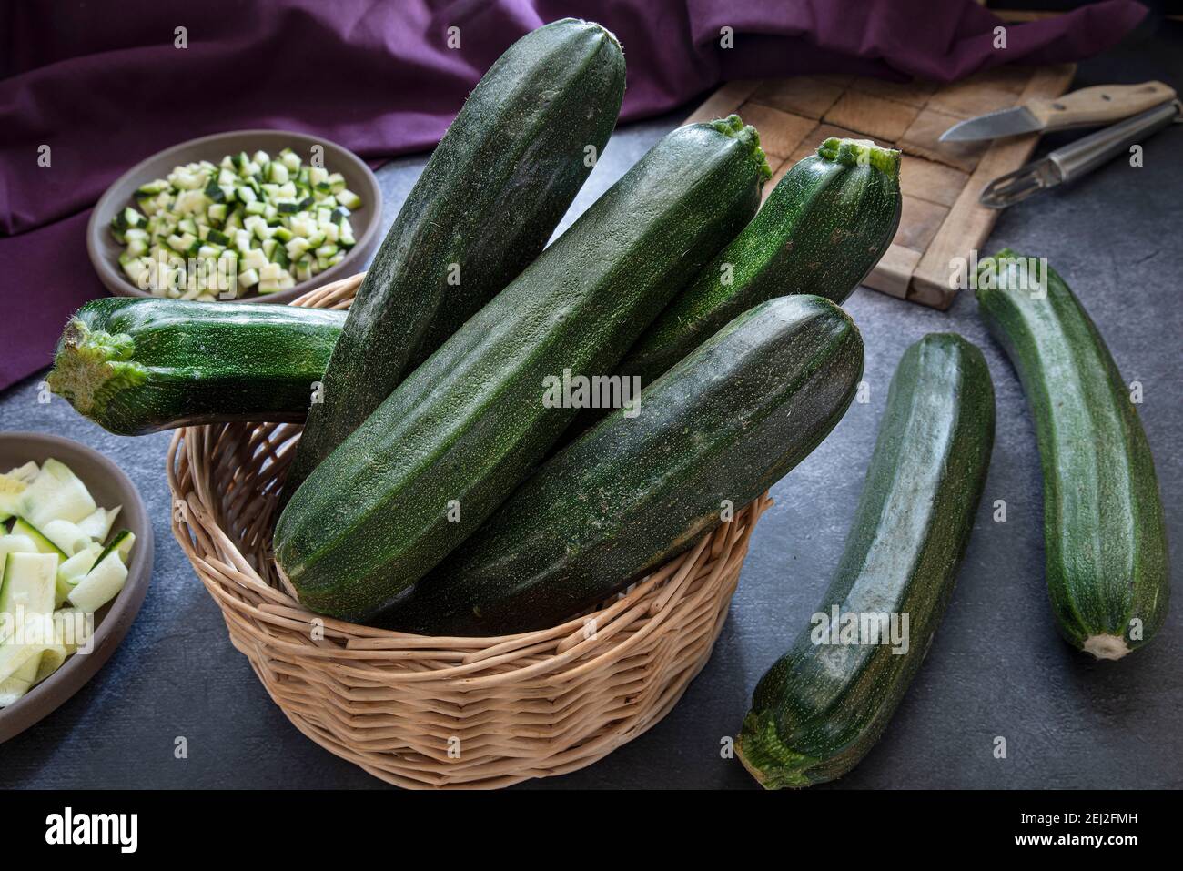 Close-up of courgettes in a wicker basket on a kitchen table Stock ...