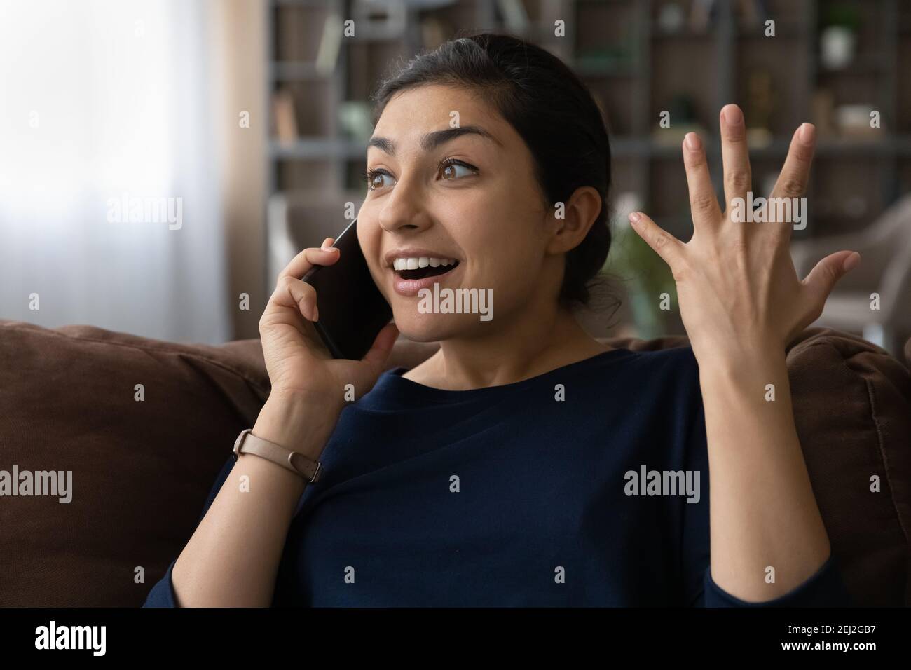 Surprised young Indian woman shocked by news on cell Stock Photo - Alamy