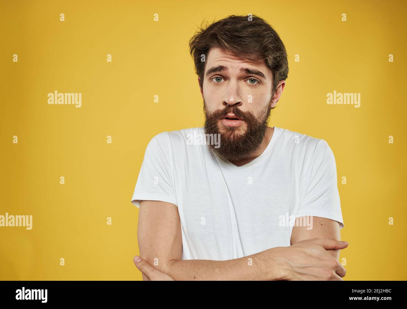 Emotions model irritability sad face yellow background man Stock Photo ...