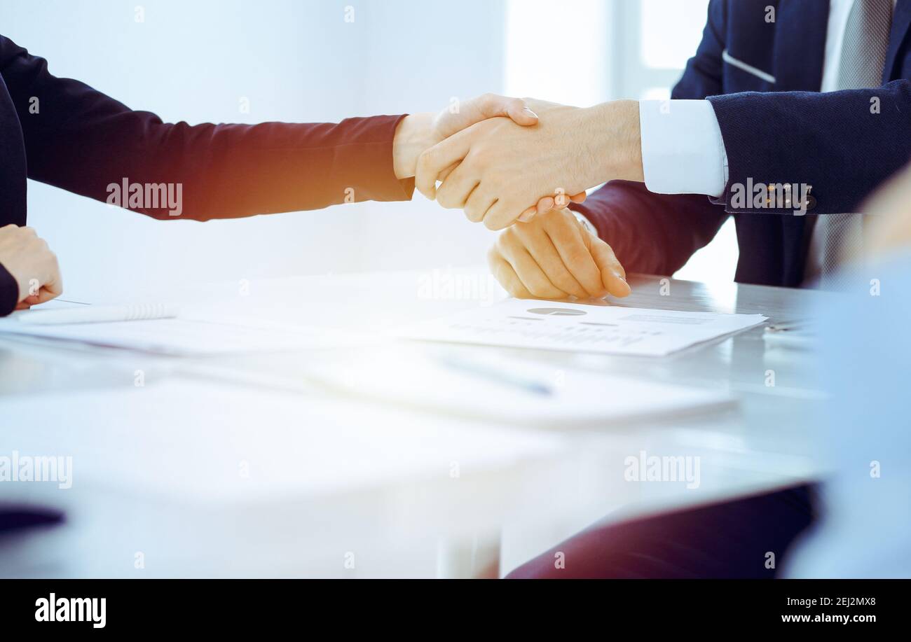 Businesspeople or lawyers shaking hands finishing up meeting or ...