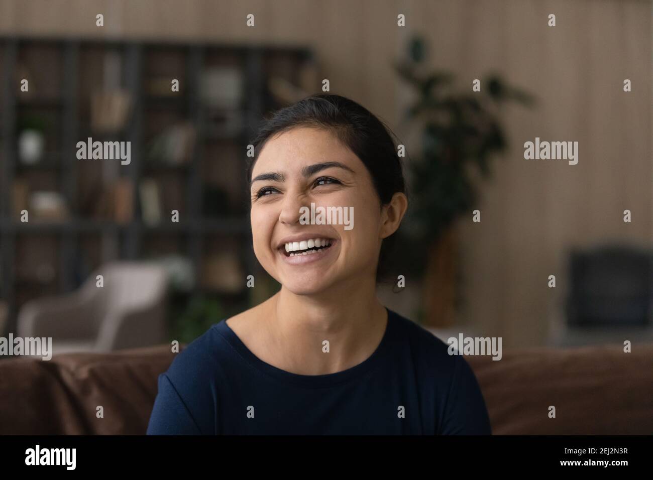 Happy young Indian female feel overjoyed relaxing at home Stock Photo ...