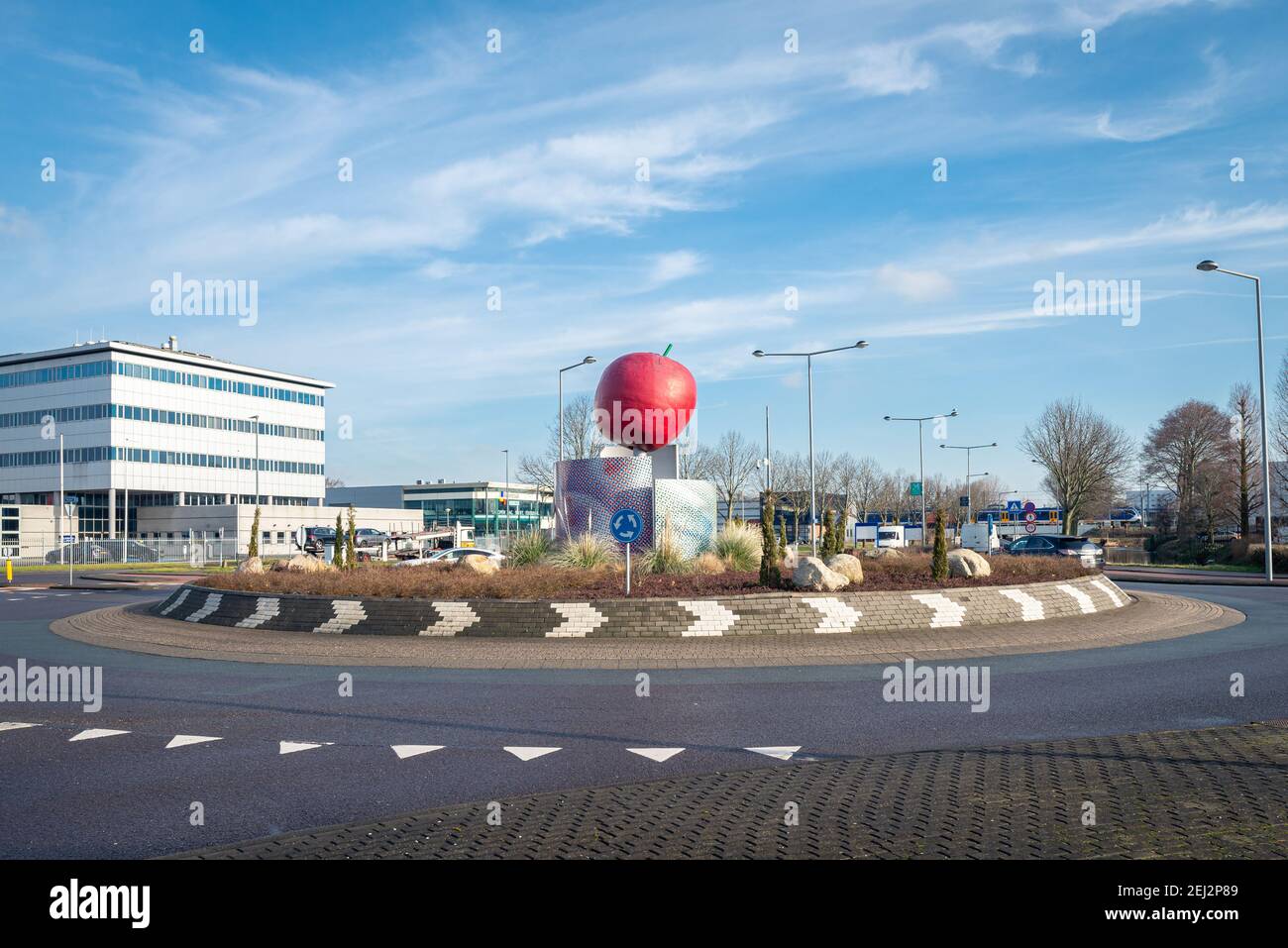 Large plastic red apple on a roundabout in business park Stock Photo ...