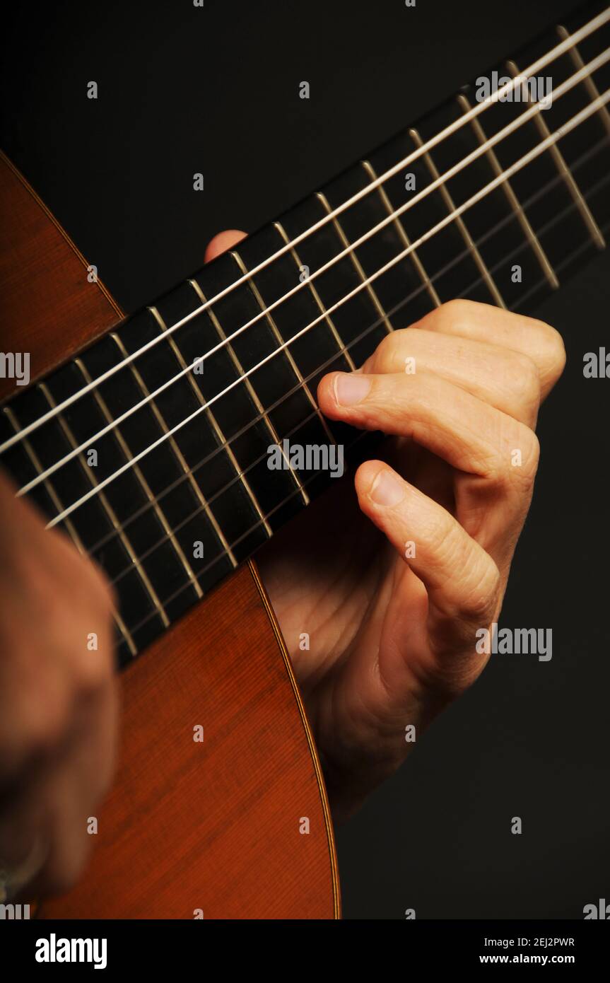 Close up of an acoustic guitar being played by a woman Stock Photo - Alamy