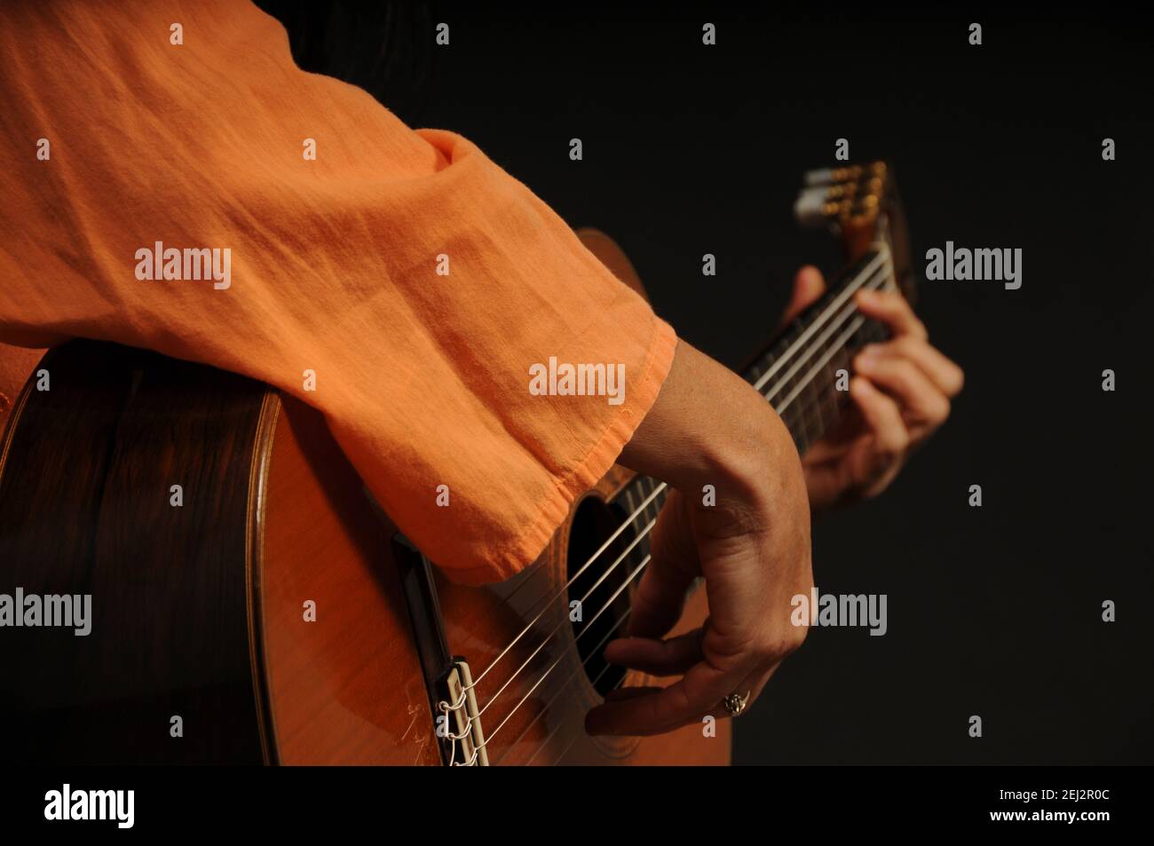 Close up of an acoustic guitar being played by a woman Stock Photo - Alamy