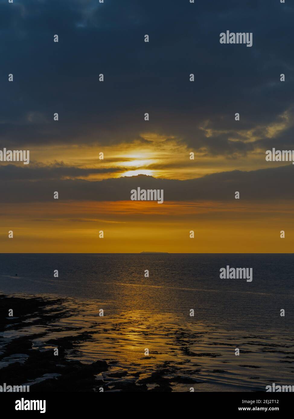 The sun about to set over the horizon Stock Photo - Alamy