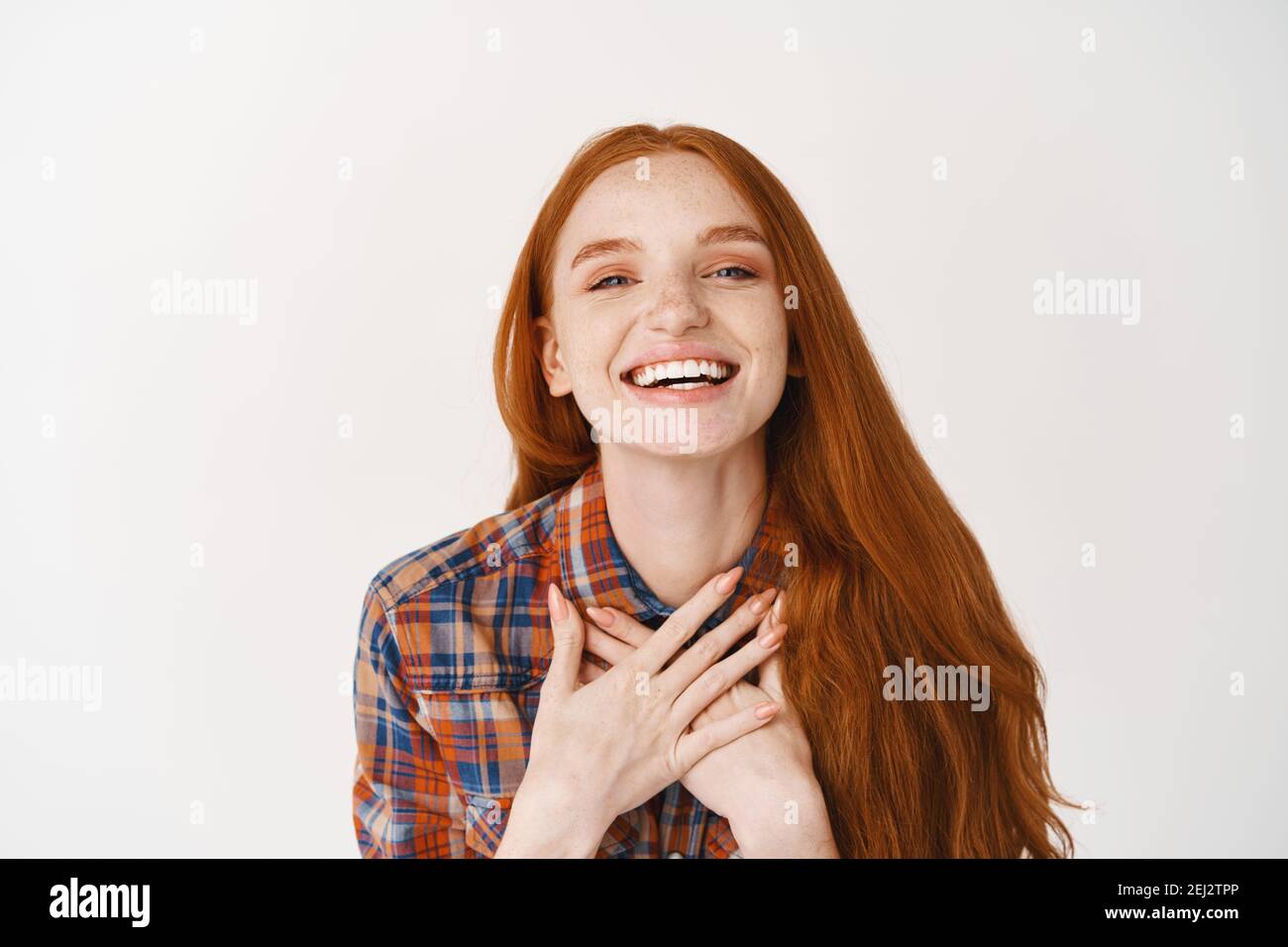 Close-up of happy ginger girl with pale skin and blue eyes smiling ...