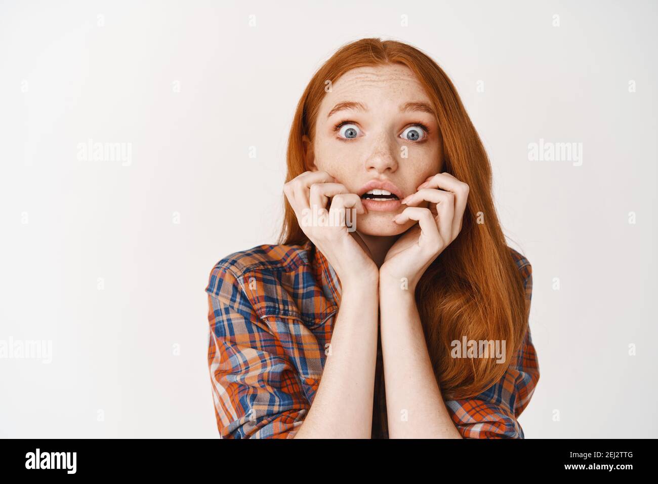Close-up of amazed redhead girl listening with interesting, biting ...