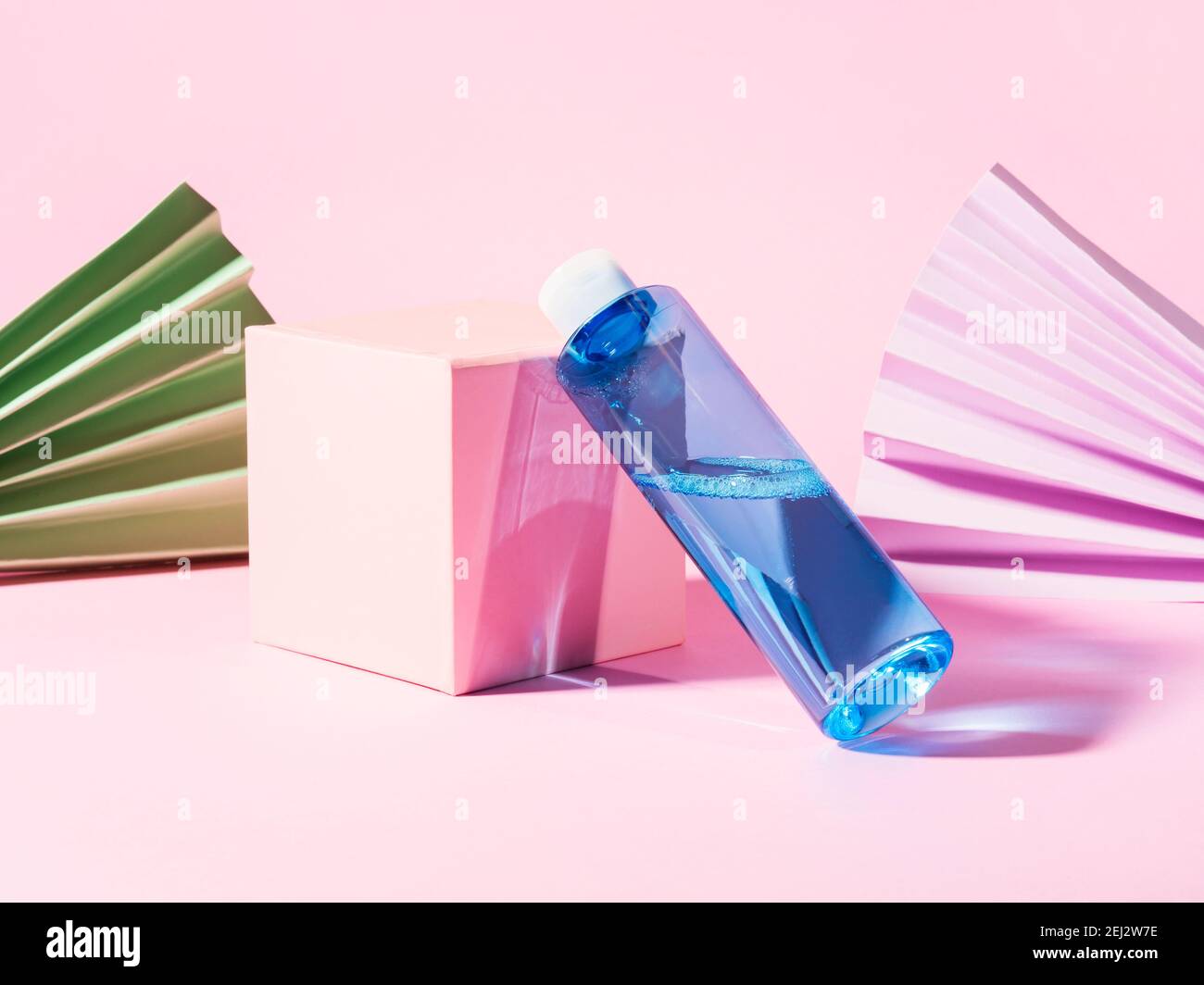 Blue skin care toner bottle on pink geometrical background Stock Photo ...