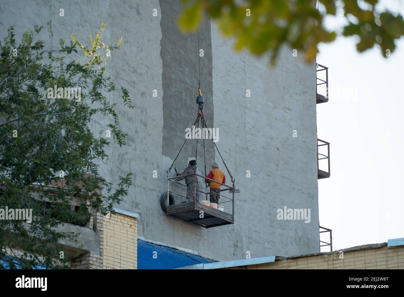 Repair a building, skyscraper, or structure with a crane. Repair of a ...