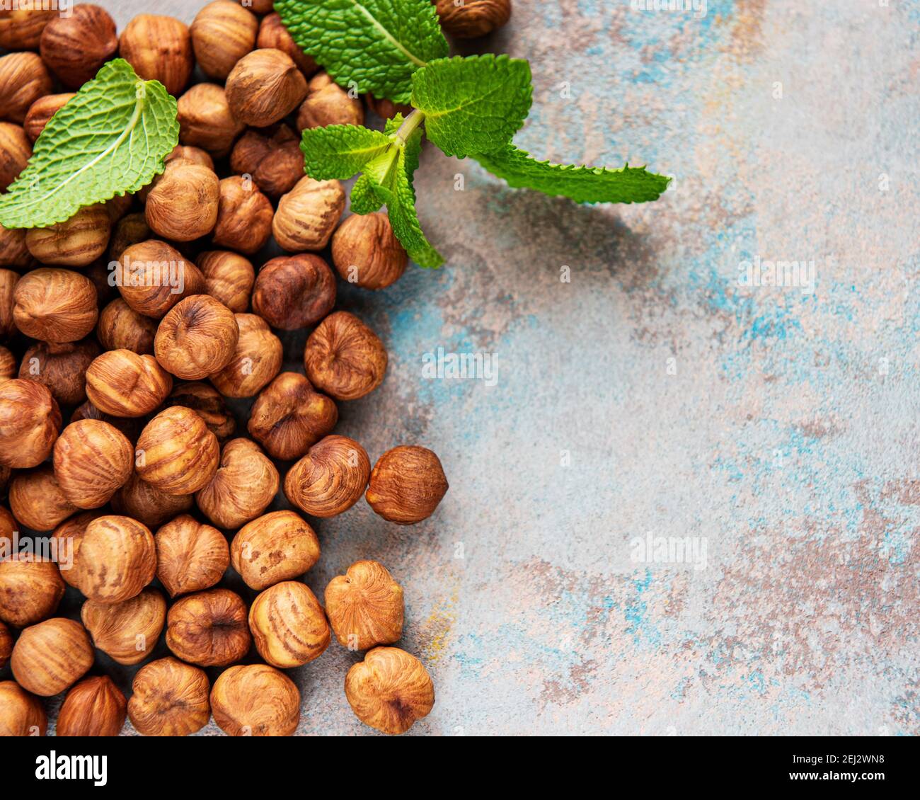 Peeled hazelnuts on a grey concrete background Stock Photo - Alamy