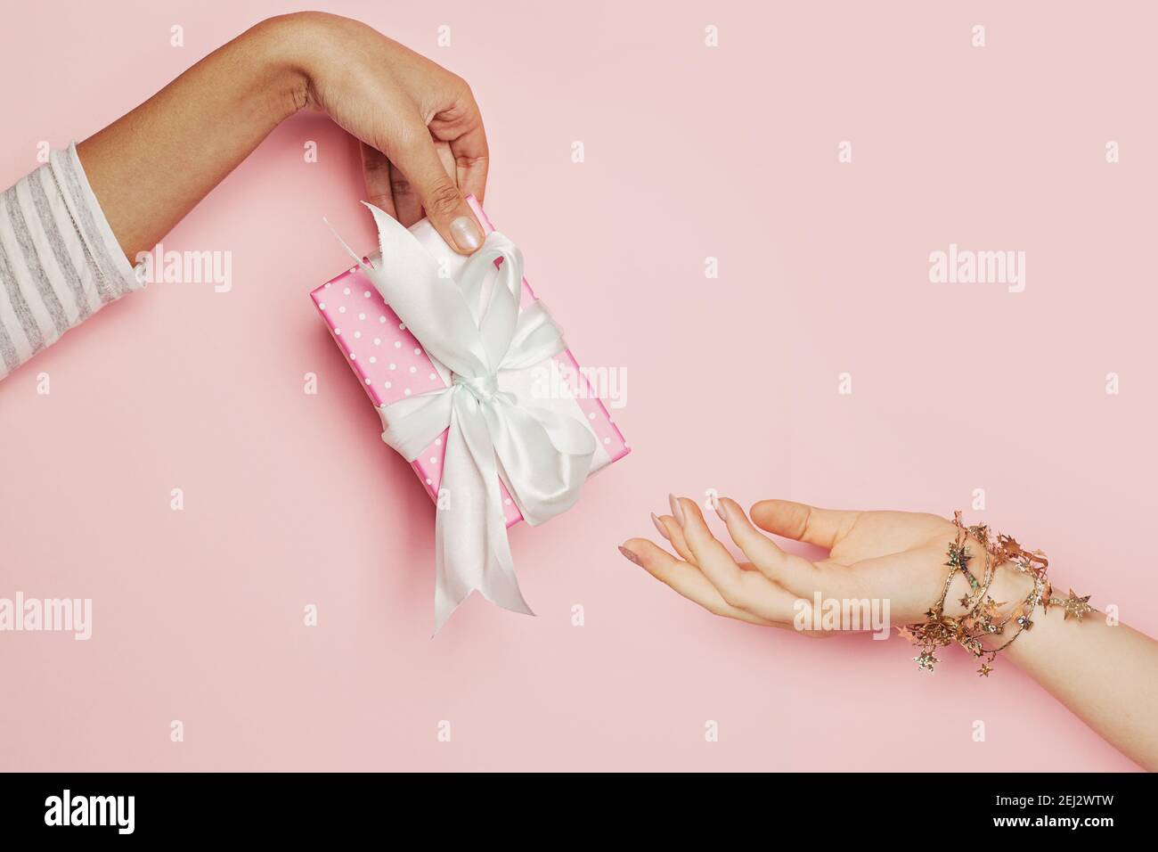 Gift and giving and taking woman hands, minimal background composition ...