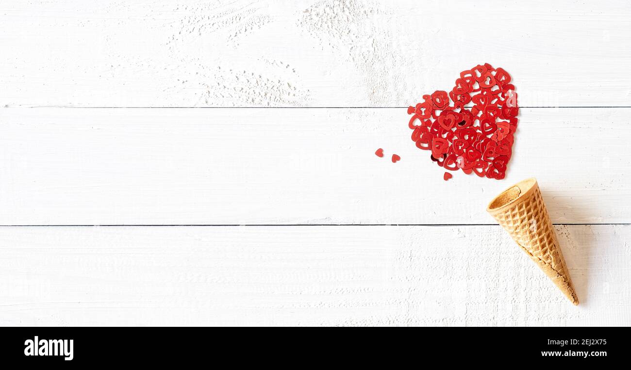 ice-cream corn on white wooden background with red heart shape ...
