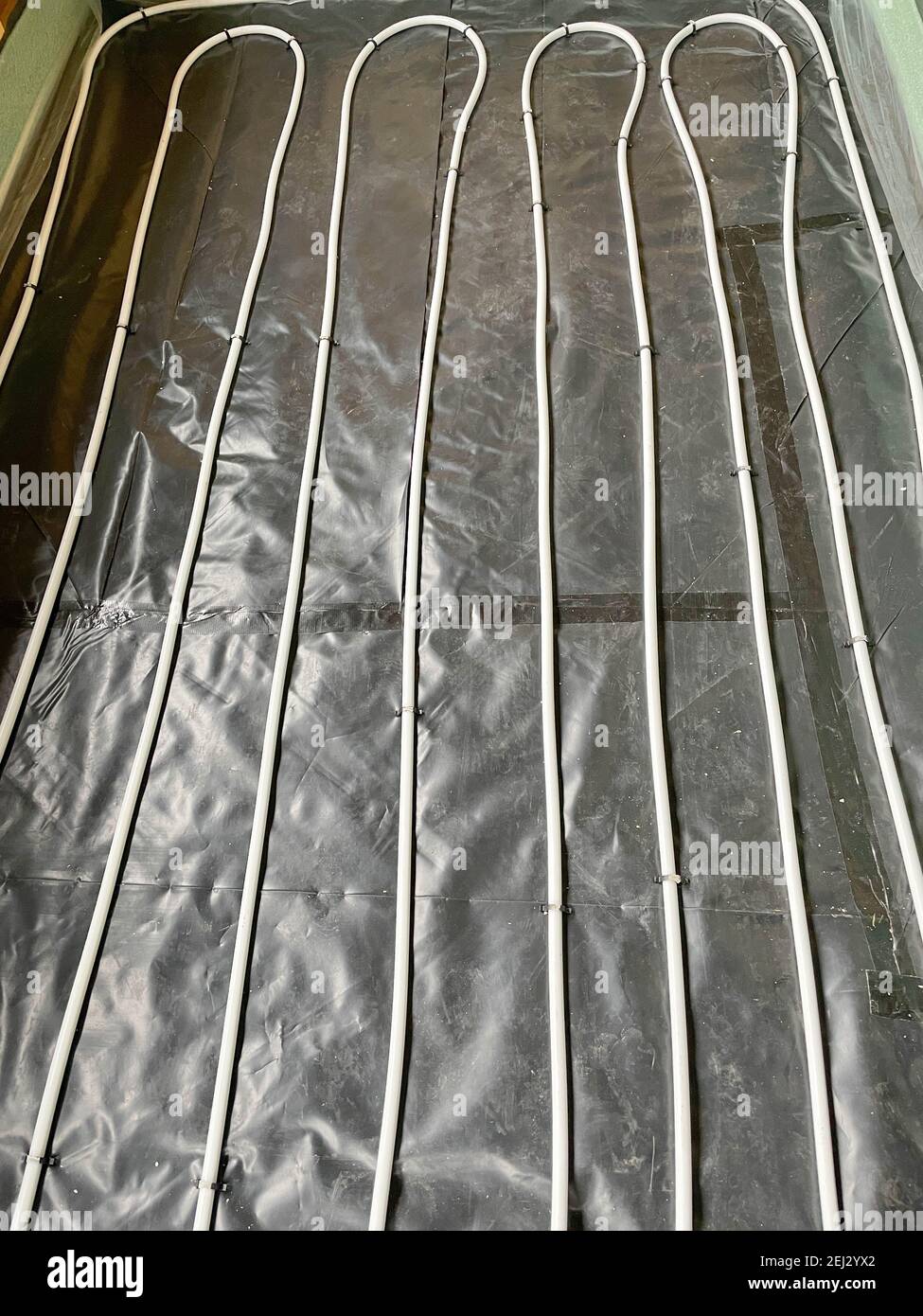 Underfloor Heating Pipes Laid on Top of Black Plastic Sheets on the ...