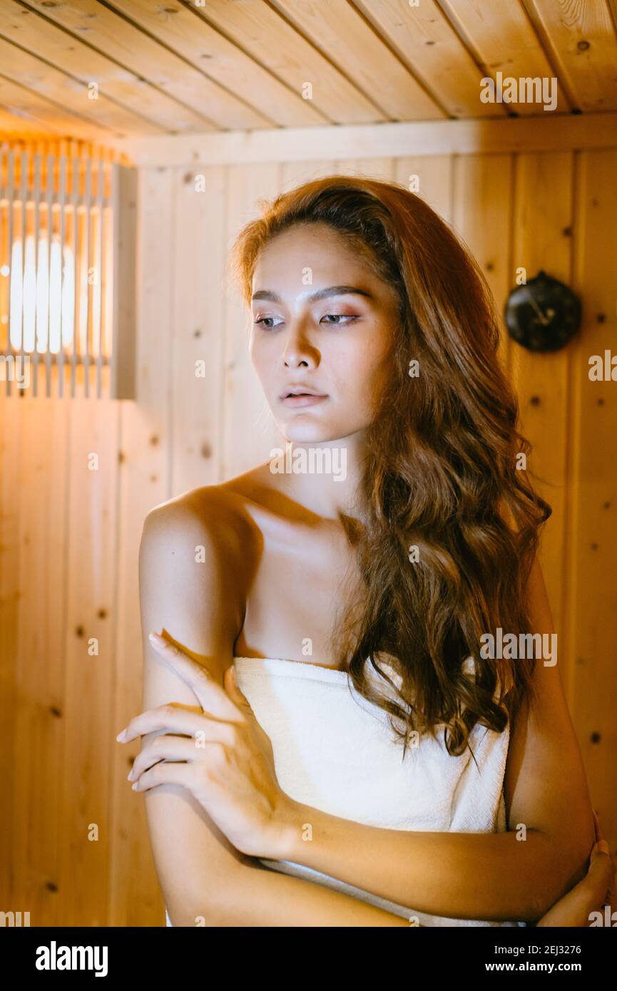Portrait of a beautiful young Asian transgender model in a sauna room ...