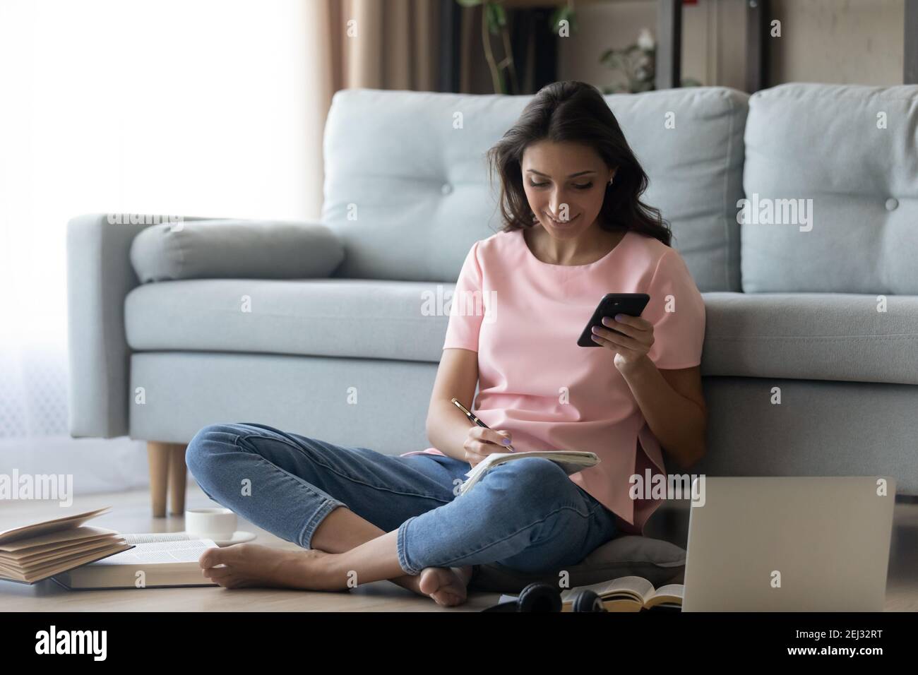 Indian female student searching learning content online writing up ...