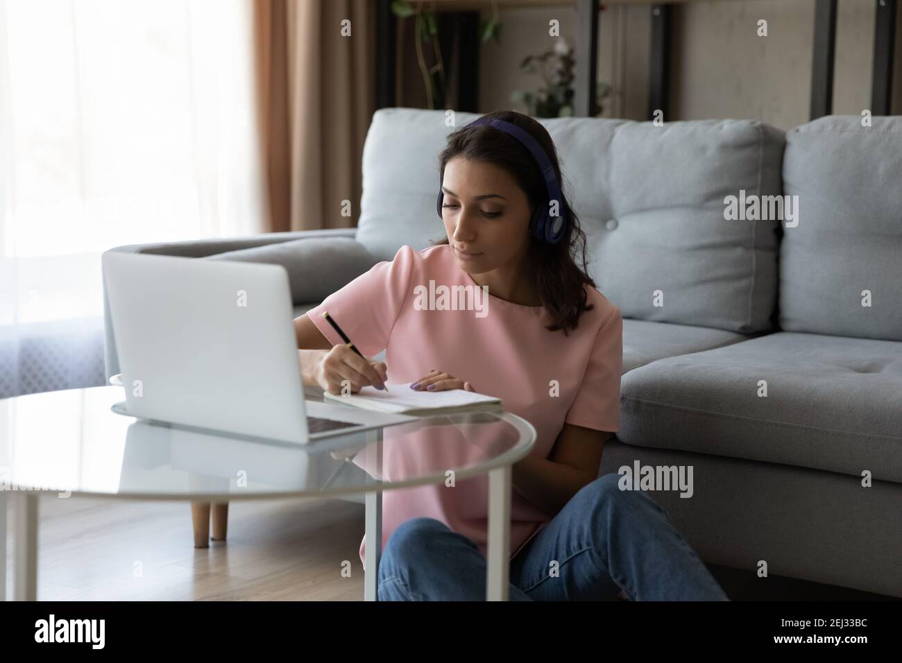 Arabic female interpreter work from home office using laptop earphones ...
