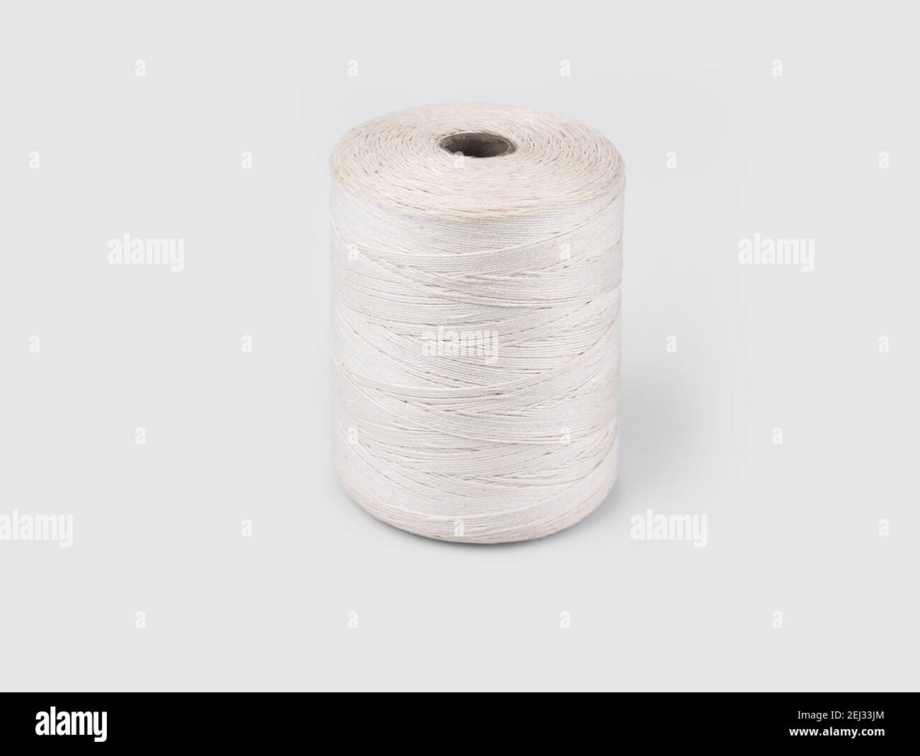 Roll of thin string on a white background Stock Photo - Alamy
