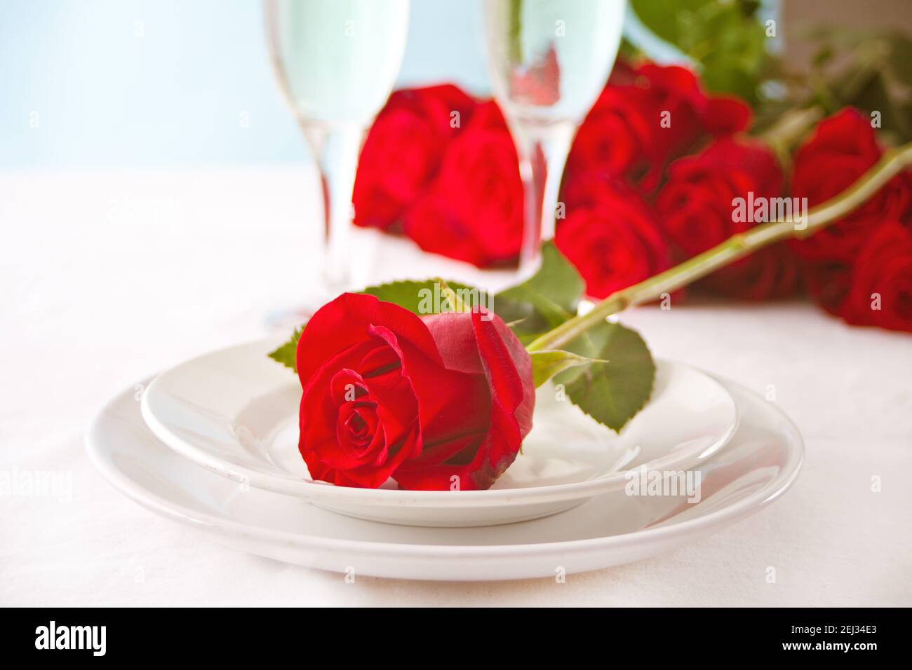 Romantic restaurant table setting for two with roses on the plate Stock ...